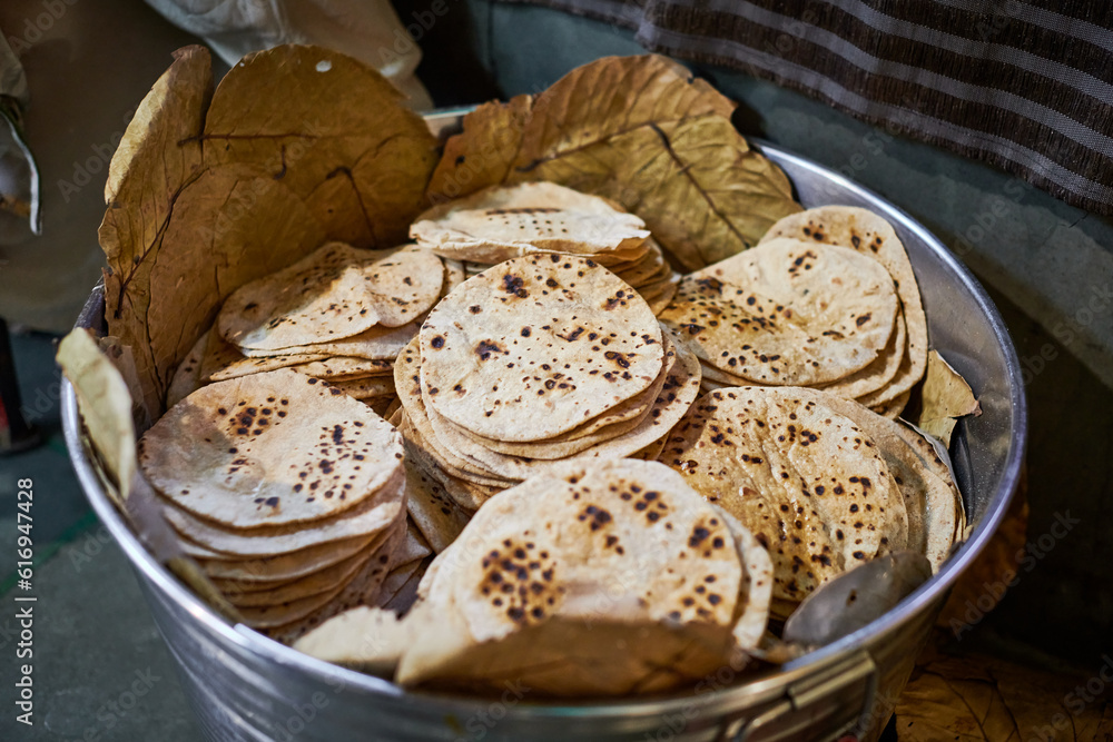 Batch of chapati round flatbreads in bucket for langar in sikh ...