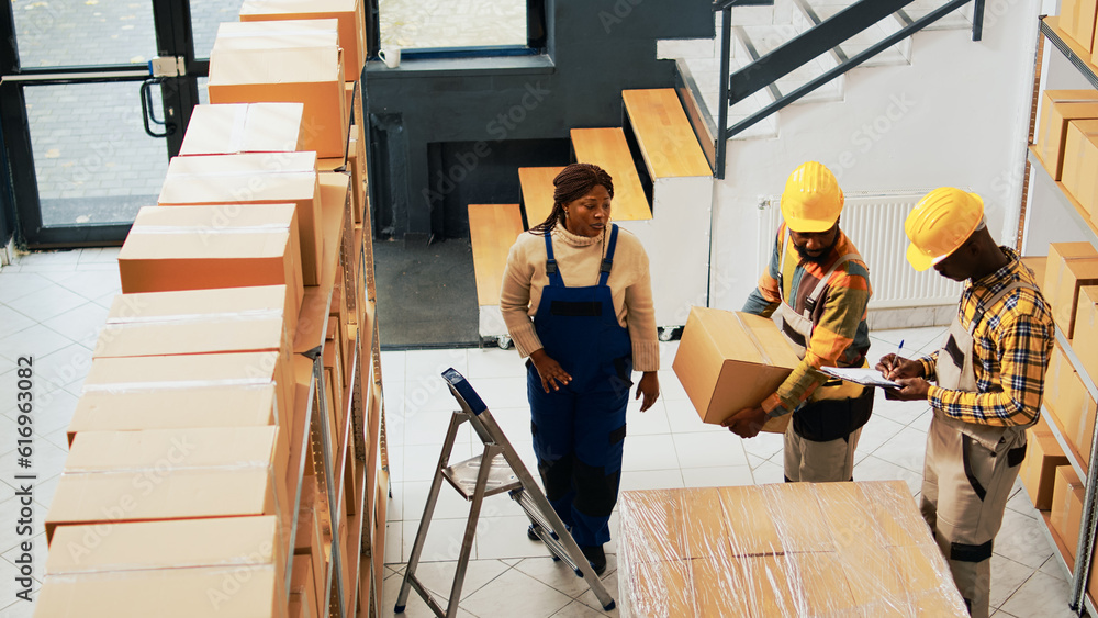 African american people organizing products in boxes, putting packages ...