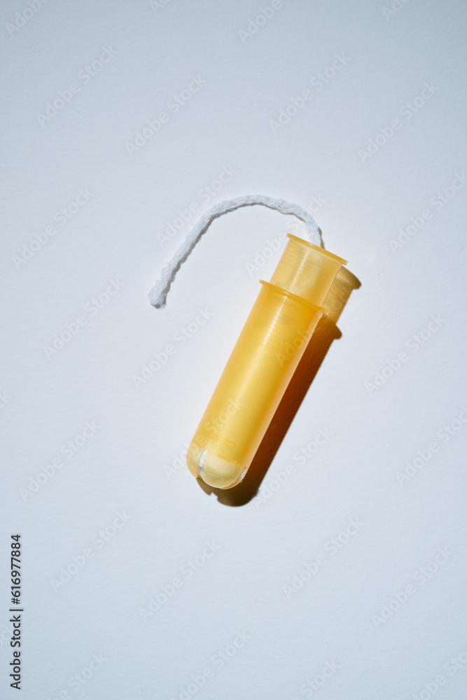 Women protection. Female yellow tampon with applicator on white ...