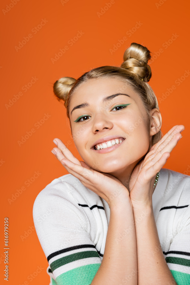Portrait of positive blonde teenager with hairstyle and bold makeup ...