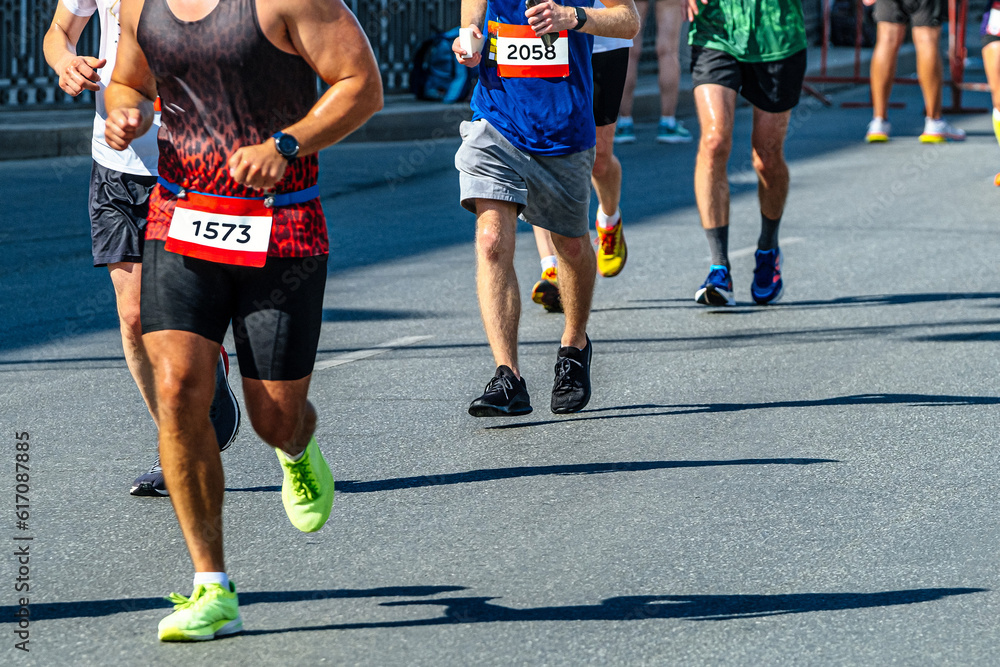 side view group male runners run together in line marathon race ...