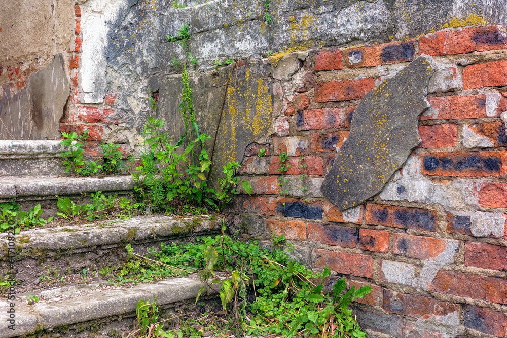 Old destroyed stone steps with old red brick wallin summer in daytime ...