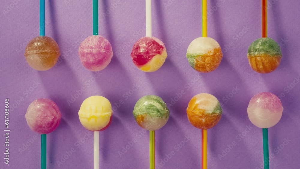 Sweet lollipops on color purple background zoom frame . Bright texture ...