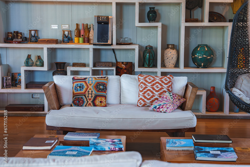 Luxury living room with antique pots and books on shelf of Costa Rica ...