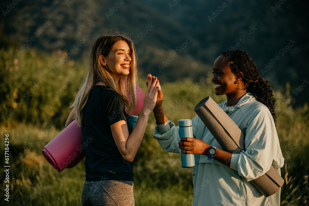 Unity in Nature: Against a backdrop of vibrant foliage, two women of ...