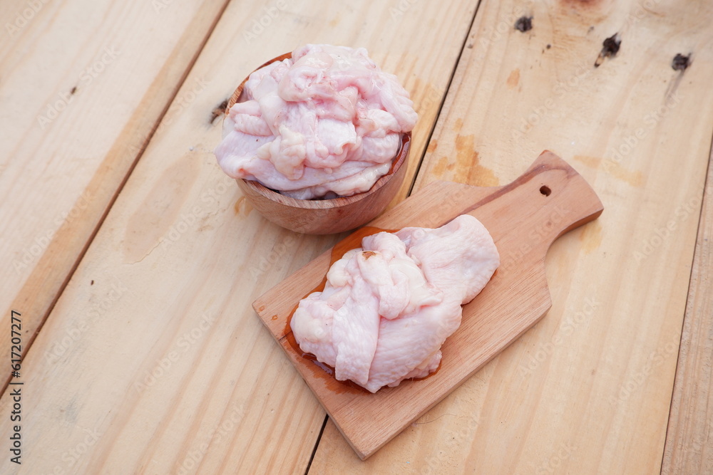 selective focus on piles of chicken skin that are raw and ready to be ...