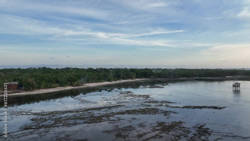 Drone shot panning to show eco tourism and surf camp located shoreline ...