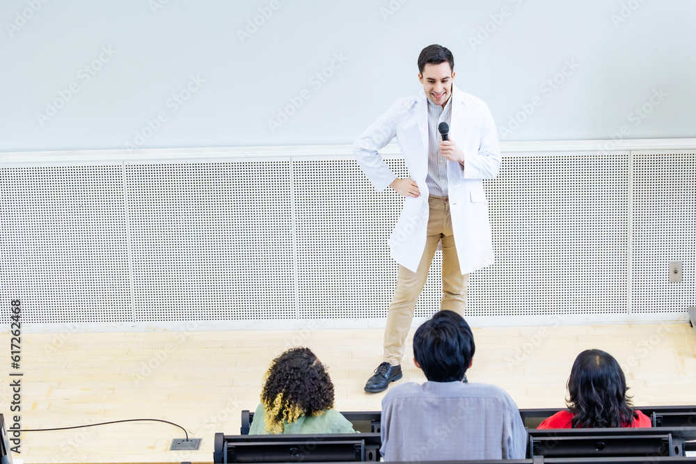 Male lecturer giving a lecture in the auditorium. University professor ...