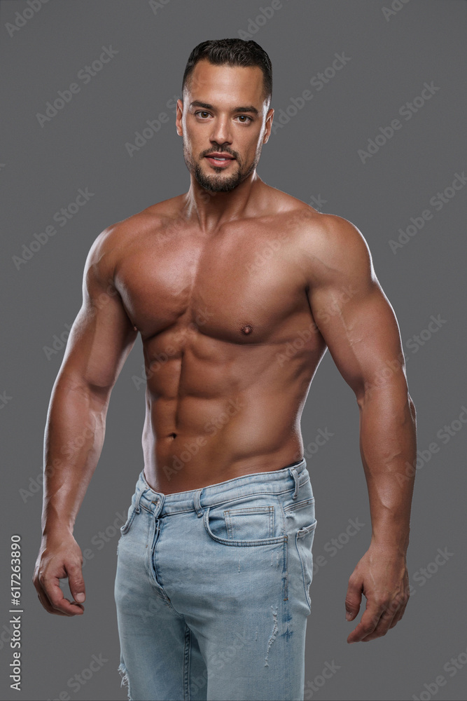 Strikingly handsome male model with a well-built physique poses ...
