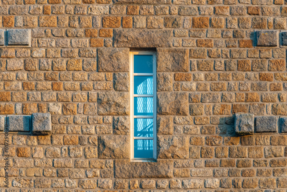Old window on the wall. A window on the stone wall of a tower. Through ...