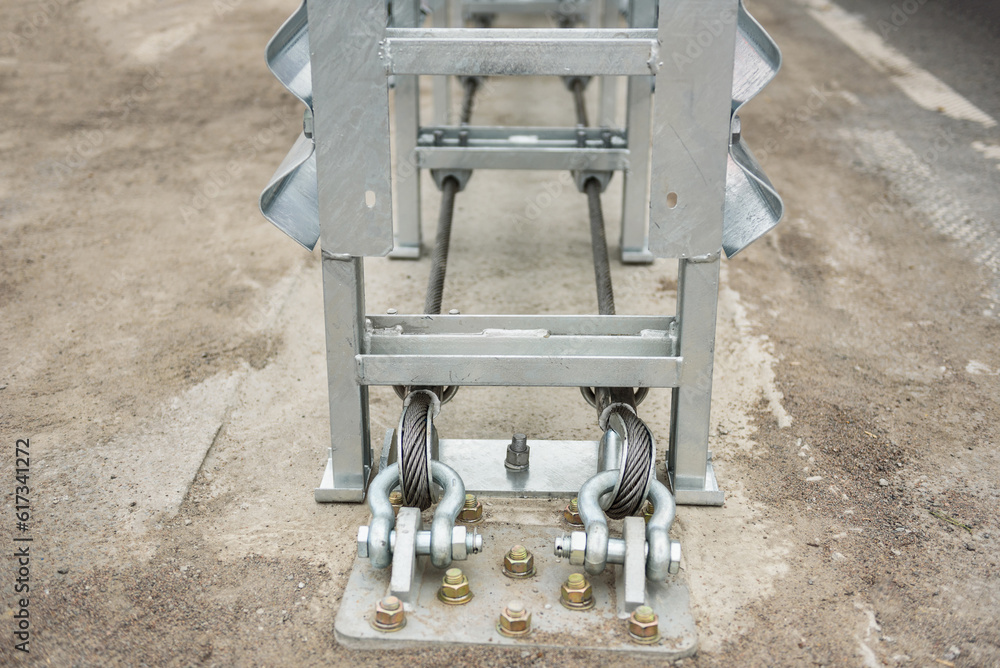 Cable tensioning. Installation of support in crash barriers on highway ...