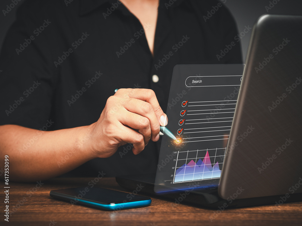 Businessman holding a pen and writing a check mark symbol on a document ...