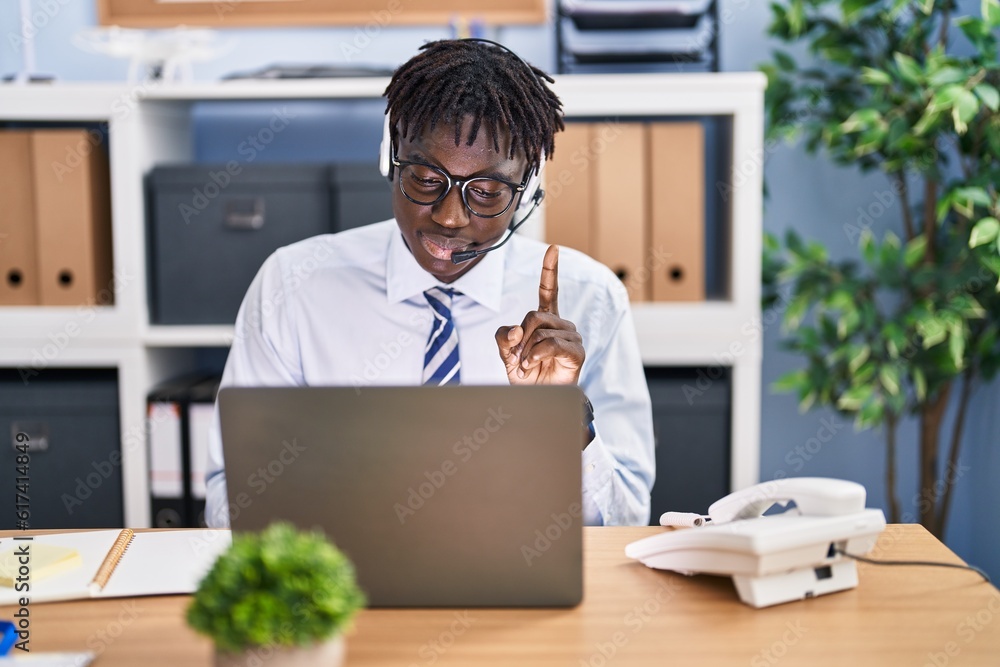 African man with dreadlocks wearing call center agent headset surprised ...