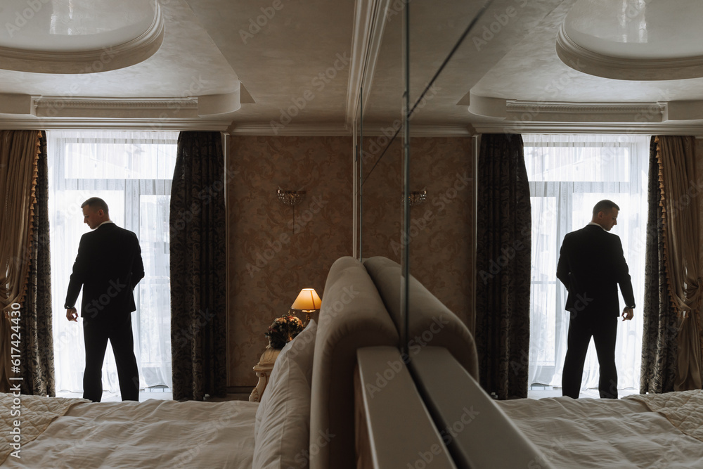 young man in his room, near the window in the hotel room, young ...