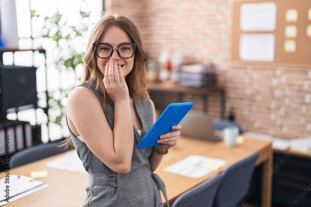 Caucasian woman working at the office wearing glasses laughing and ...