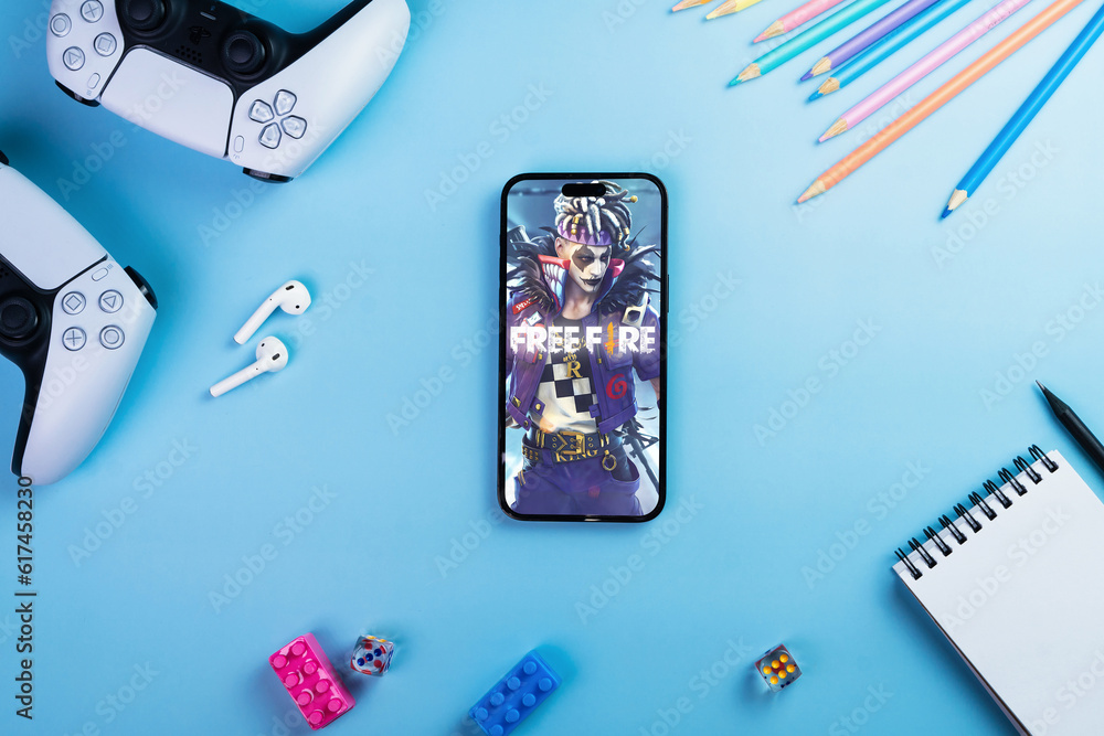 Garena Free Fire app on the smartphone iPhone 14 Pro screen on blue ...