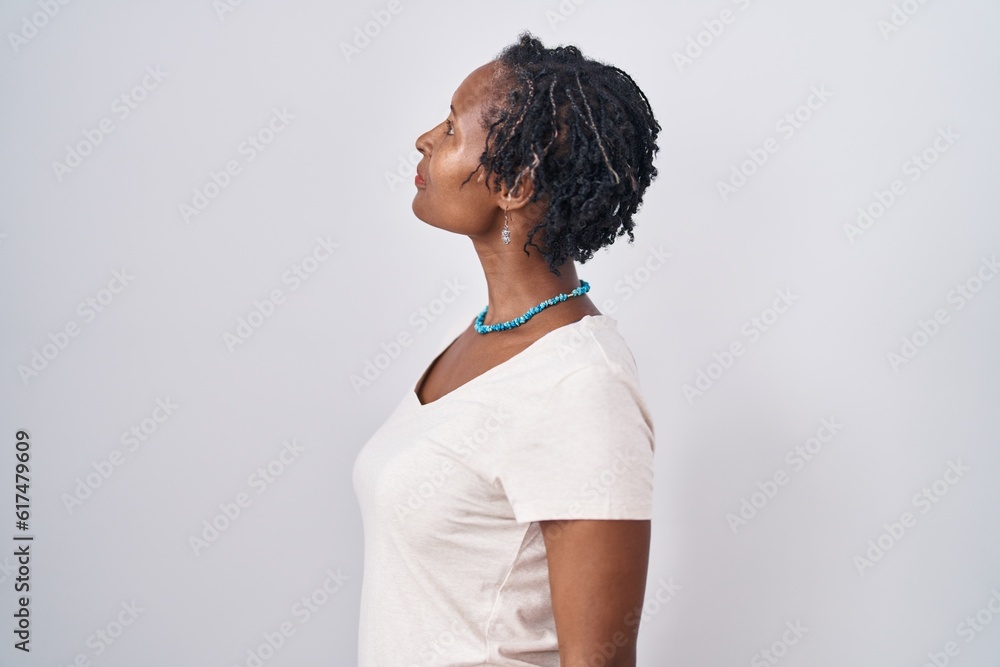 African woman with dreadlocks standing over white background looking to ...