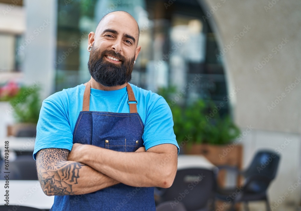 Young bald man waiter smiling confident standing with arms crossed ...