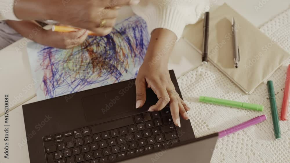 zenithal view showing the hands of a Brazilian mother using the ...