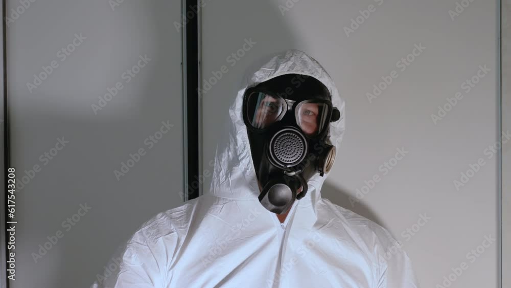 Radiation protection. A man in a chemical suit with a gas mask. Point ...