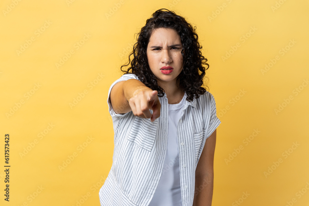 Portrait of strict woman with dark wavy hair noticing and pointing ...