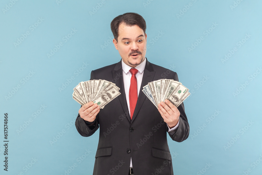 Portrait of rich man with mustache standing counting money., holding ...