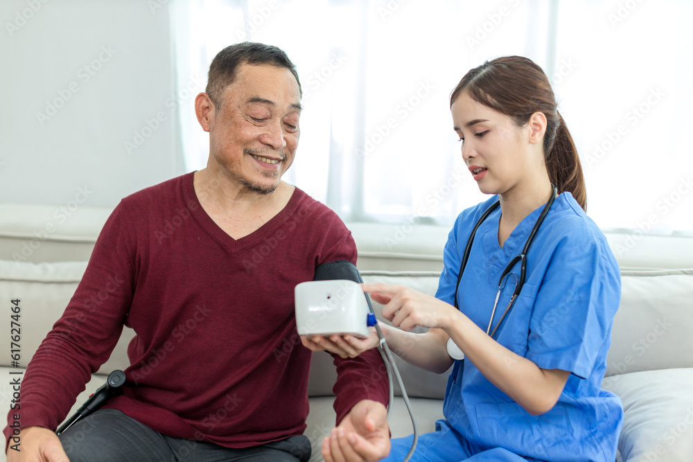 Foto de Caregiver nurse measuring blood pressure by using digital ...