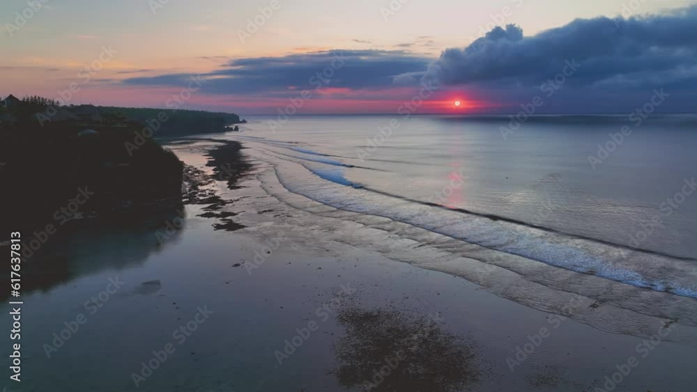 Fixed drone clip over calm beach in Bali, Indonesia with gentle rolling ...