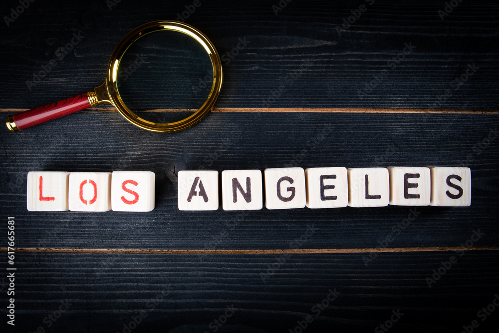 LOS ANGELES. City name from alphabet blocks on dark wood texture ...