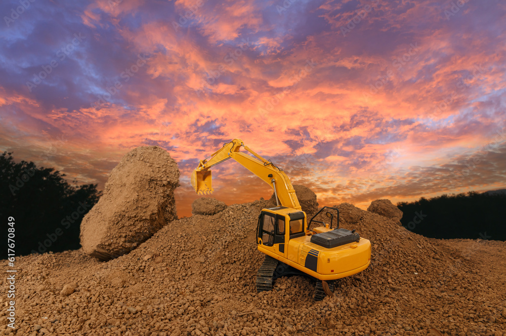 Crawler excavator is digging soil in the construction site with red sky ...