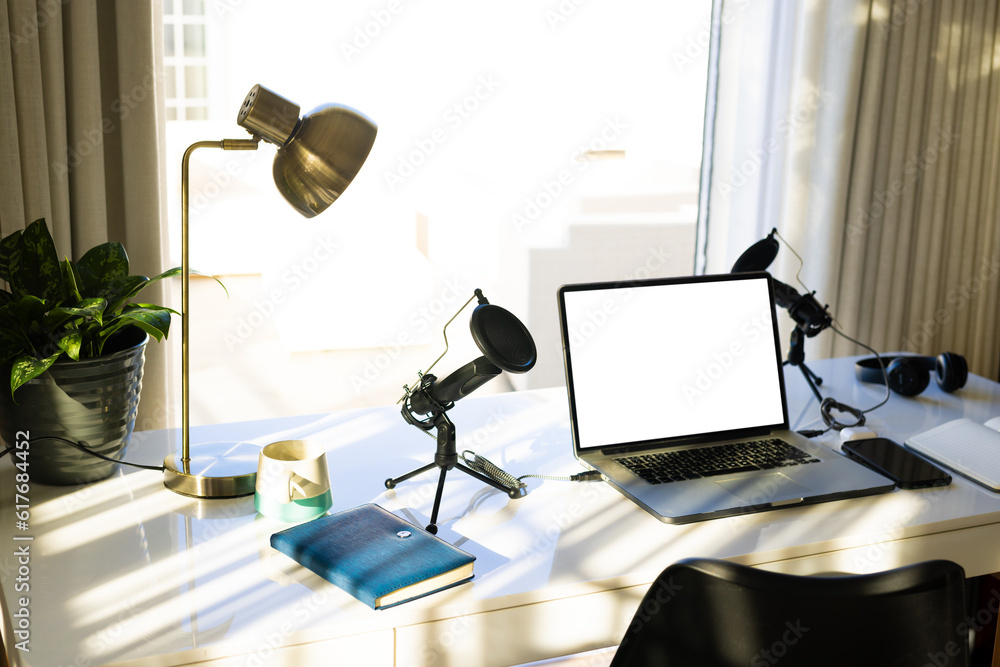 Headphones, laptop with copy space on screen and microphone on desk at ...