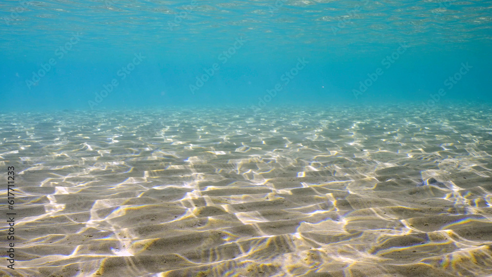 Sandy shallow water in sunburst and glare on seabed sand. Sunlight ...