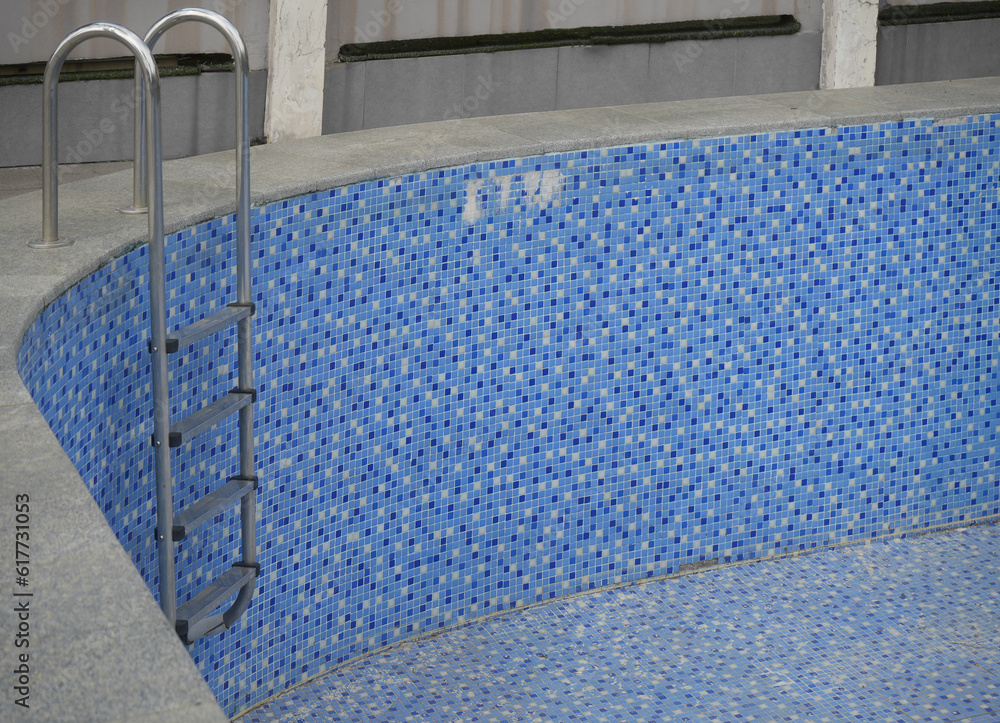 Swimming pool iron stair reach down to the pool. Semicircular metal ...