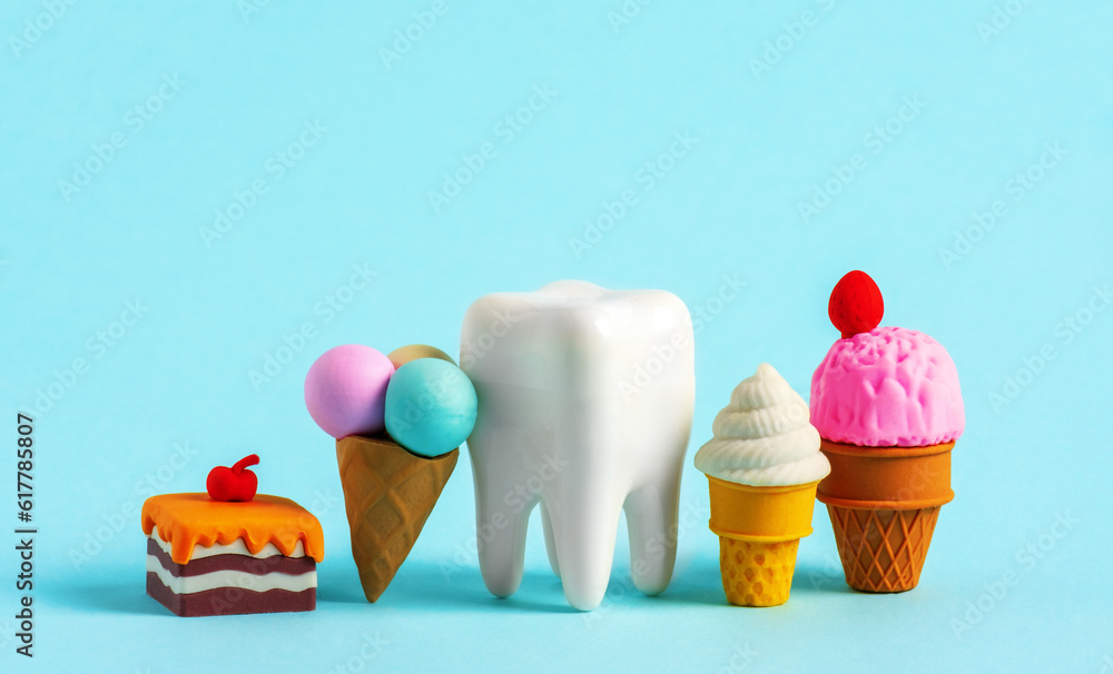 Human tooth model with tiny sweets. Unhealthy sweet food cases caries ...