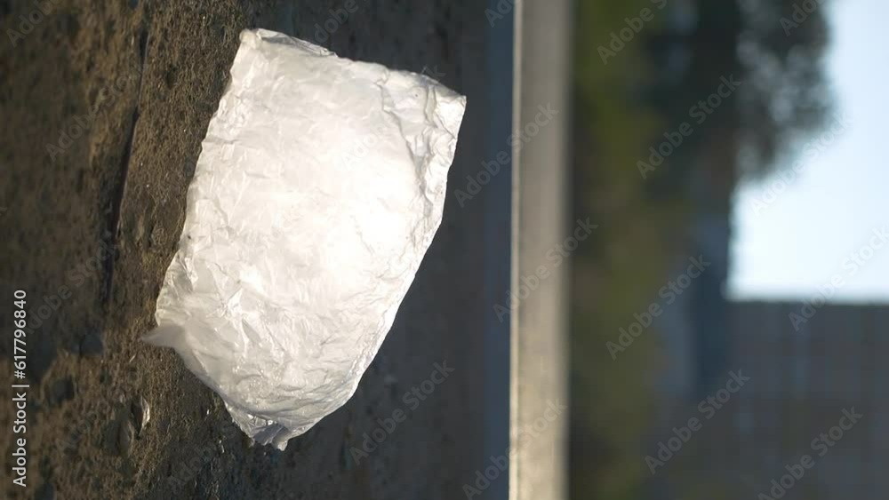 plastic bag on the ground vertical video. plastic pollution ...