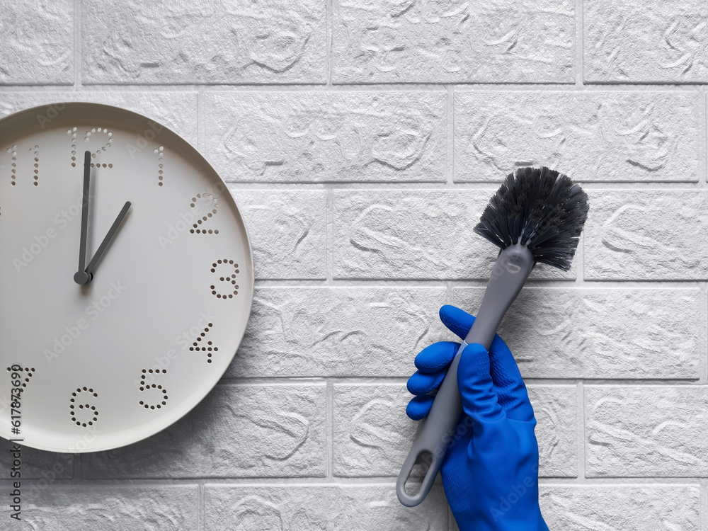 Time for cleaning and hygiene. 1 o'clock, afternoon. Hand in blue glove ...