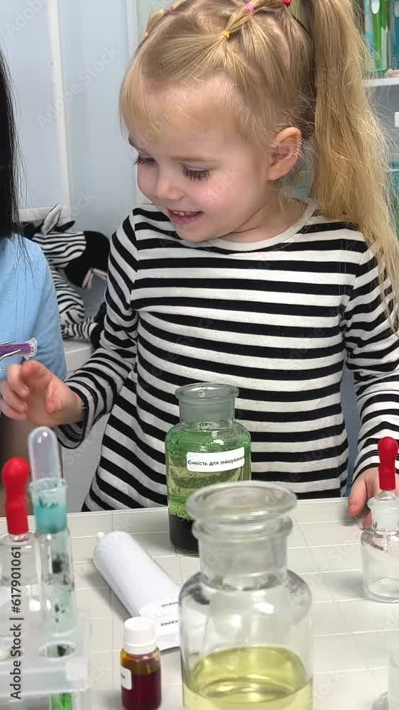 Close-up of colored science test tubes with a blurry background of two ...