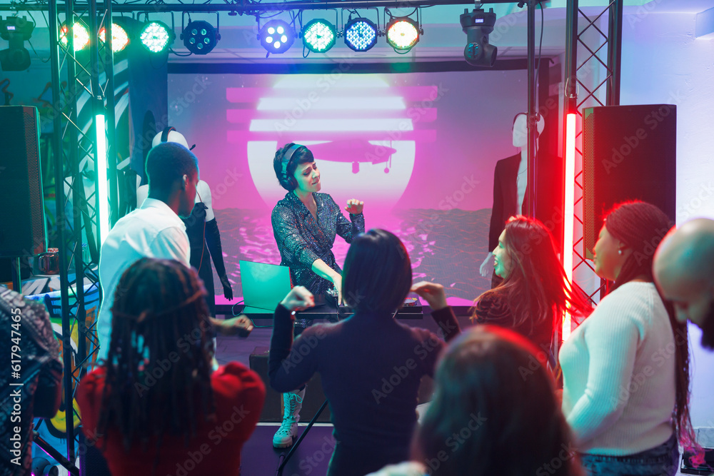 Energetic performer using dj station on stage to mix electronic music ...