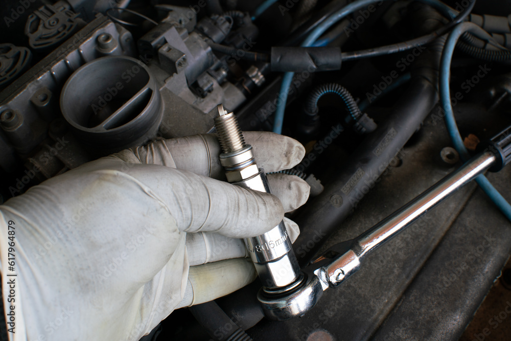 car maintenance, spark plug change operation of the internal combustion ...