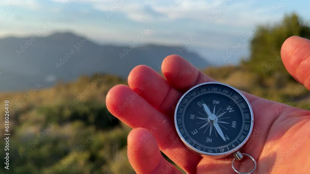 Compass in hand in mountains. Tourist compass for orientation on ...