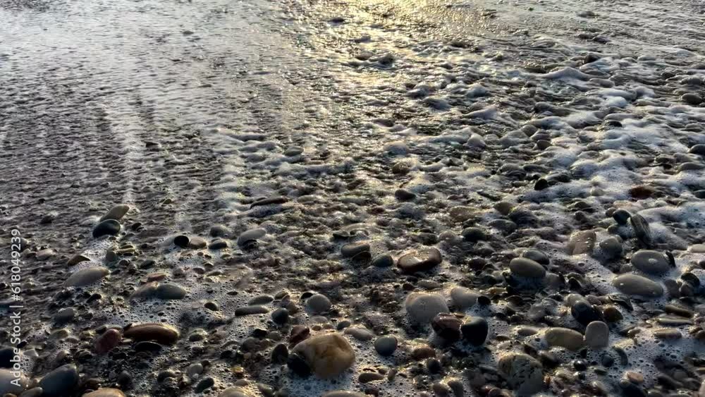 Vidéo Stock Waves in sea on sunrise. Pebble stone beach on sunset. Sea ...