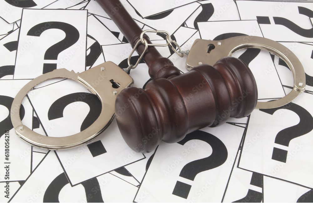 Judge gavel and handcuffs on question marks background. Concept of ...