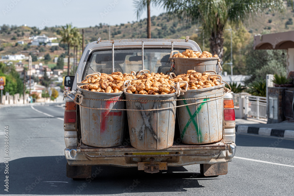 Farmers car carries on the trunk buckets of world's famous Cyprus ...