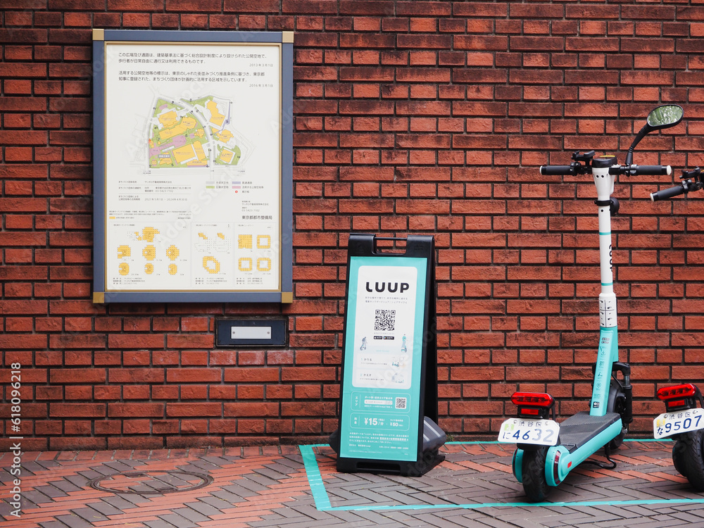 TOKYO, JAPAN - June 14, 2023: A Luup rental e-scooters by a map in ...
