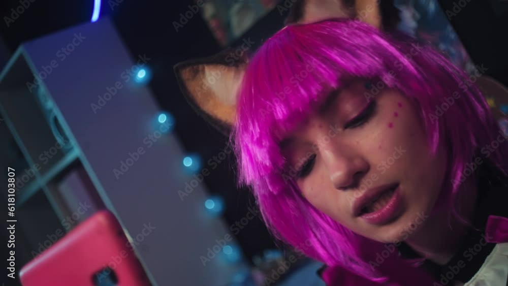 Dutch angle close-up of pretty gen Z girl wearing cute cosplay outfit ...