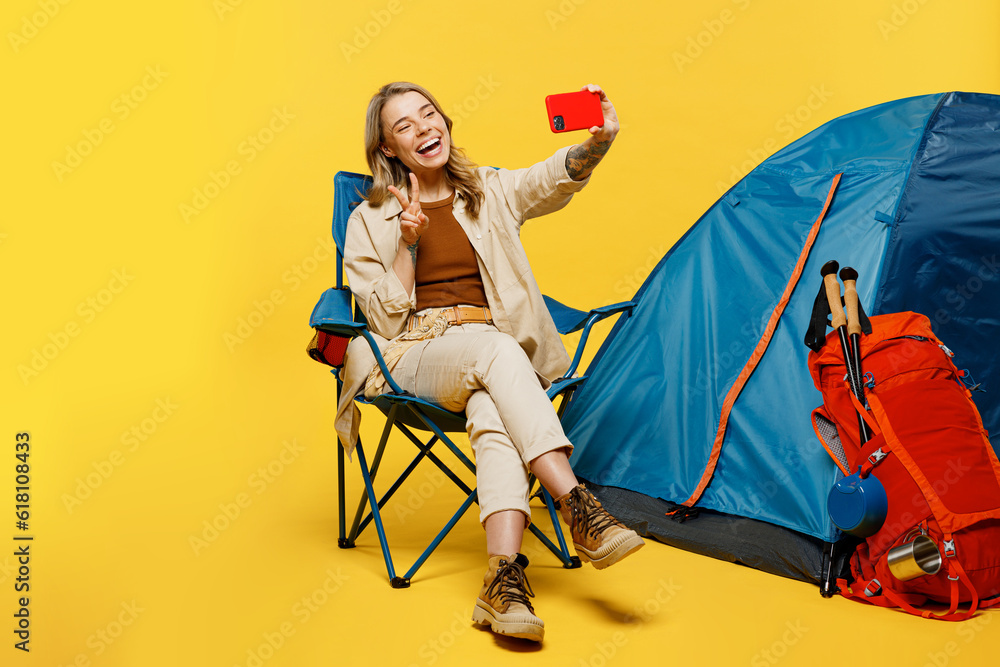 Full body young woman sit near bag stuff tent doing selfie shot mobile ...