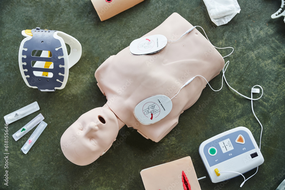 top view of CPR manikin near automated defibrillator, wound care ...