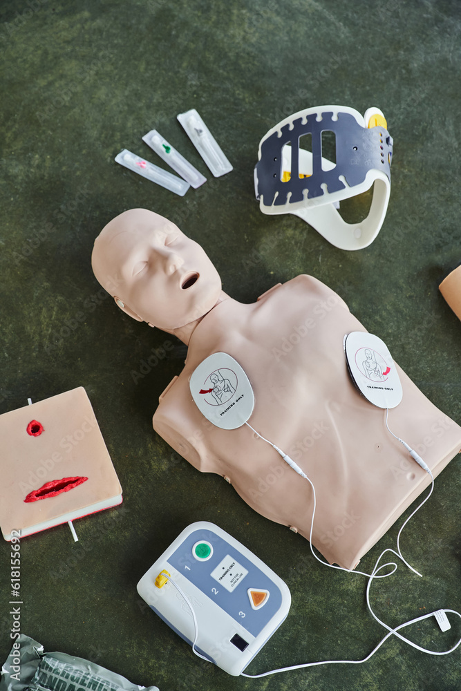 top view of CPR manikin, automated external defibrillator, wound care ...