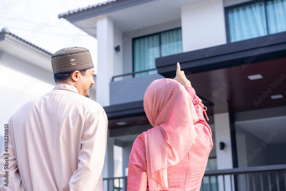 Happy muslim family standing at new home Stock Photo | Adobe Stock