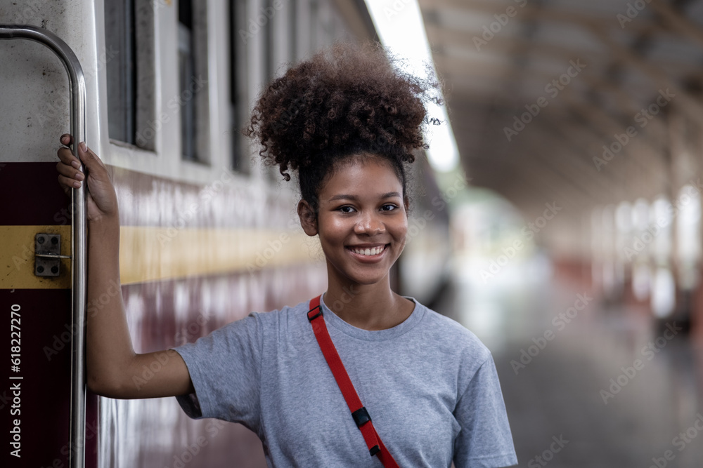 Traveler african asian american woman getting in a train to hop on ...